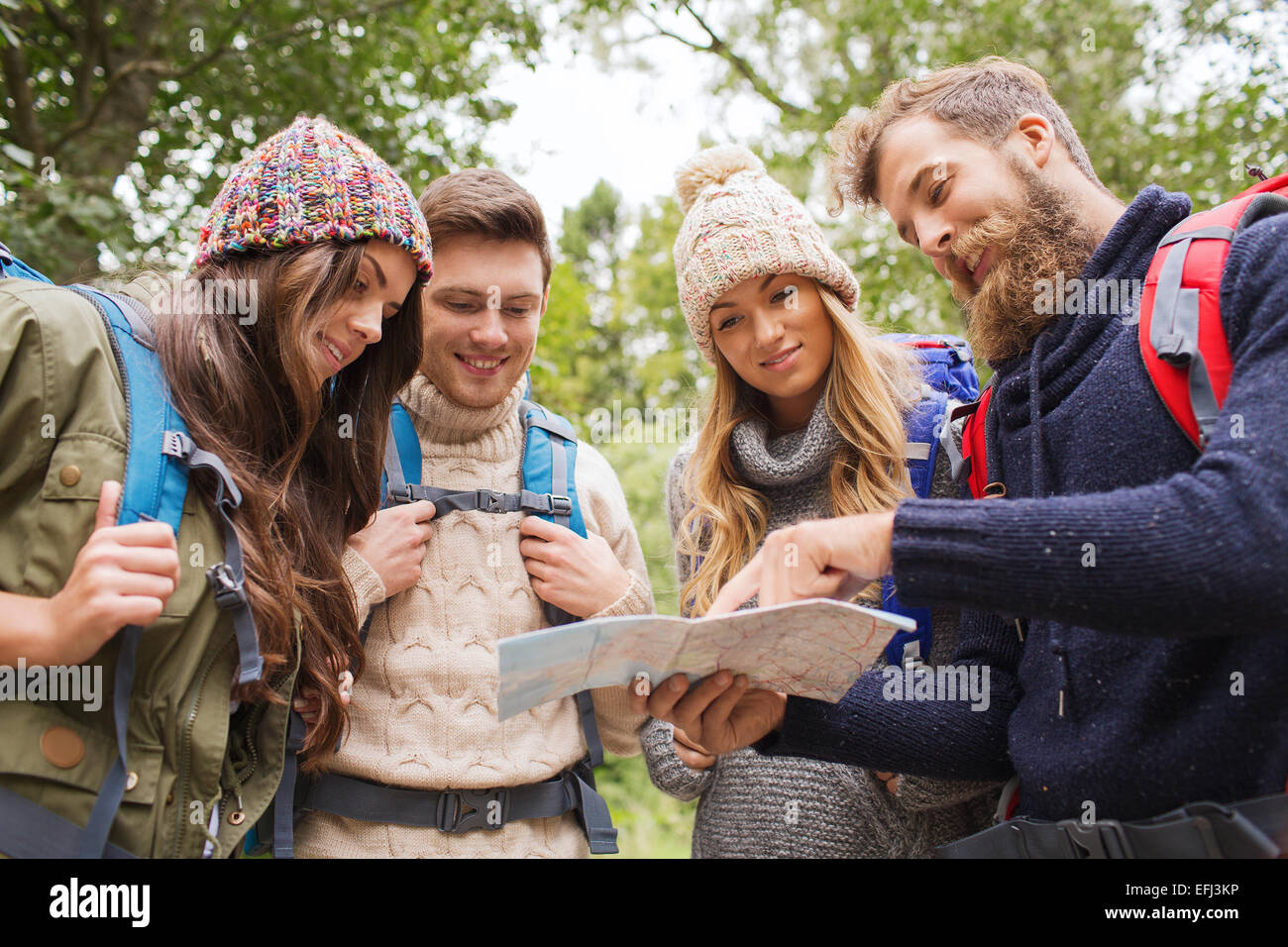 group of smiling friends with backpacks hiking Stock Photo - Alamy
