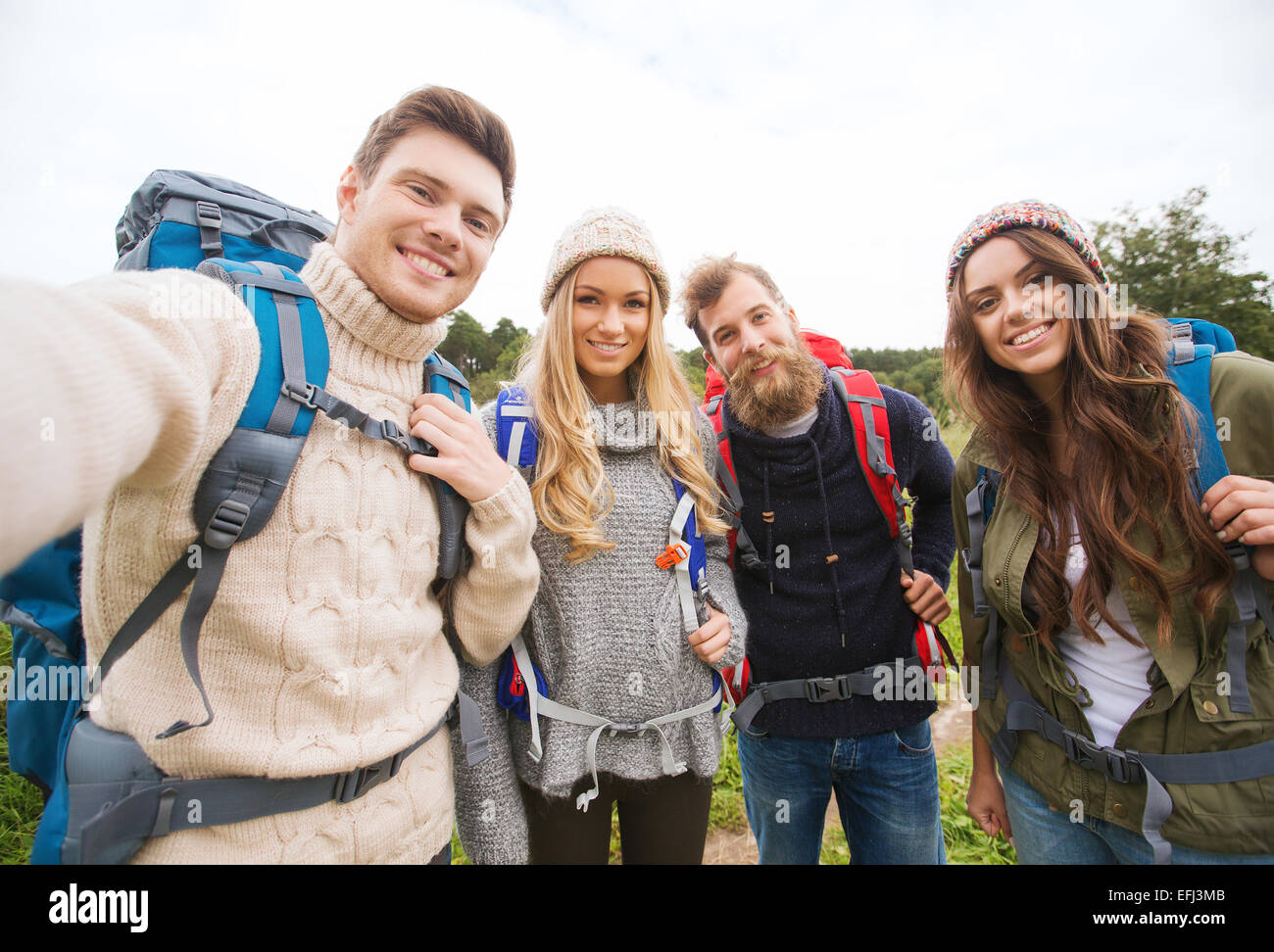 group of smiling friends with backpacks hiking Stock Photo - Alamy