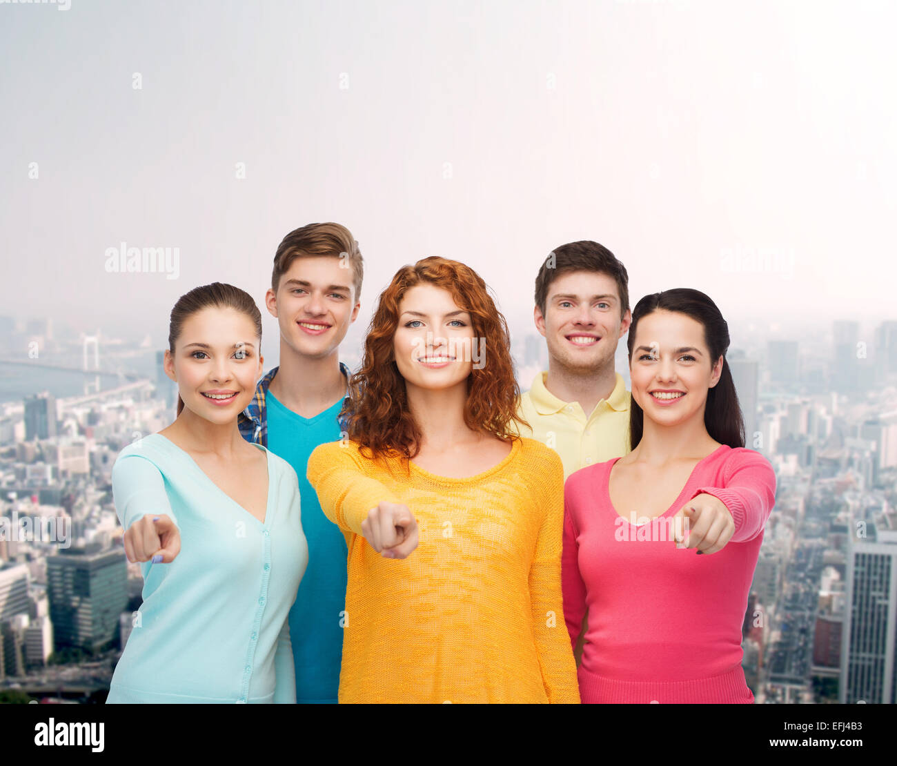 group of smiling teenagers over city background Stock Photo - Alamy