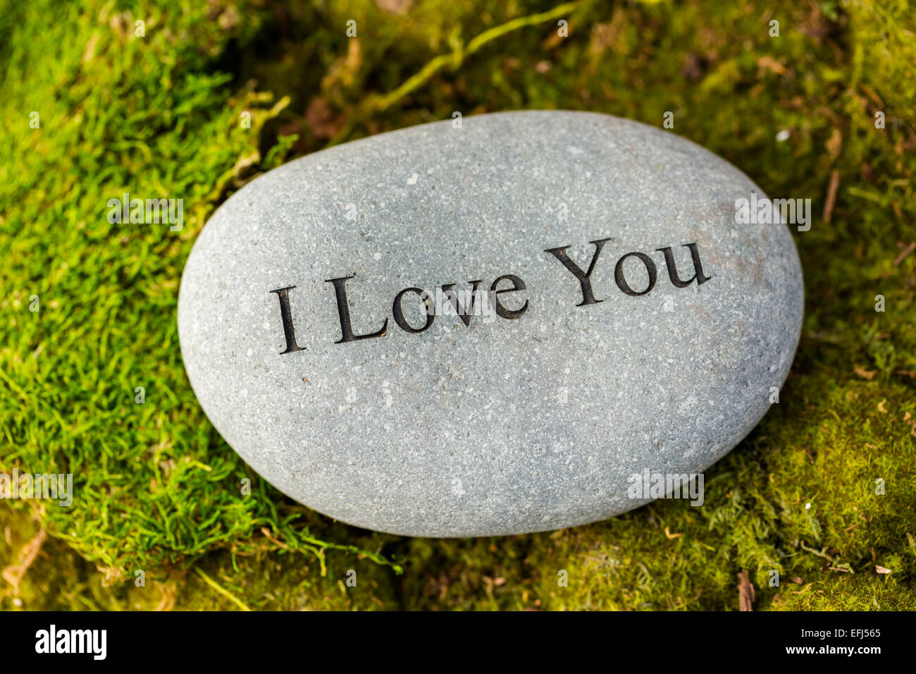 Small garden stones engraved with signs Stock Photo - Alamy