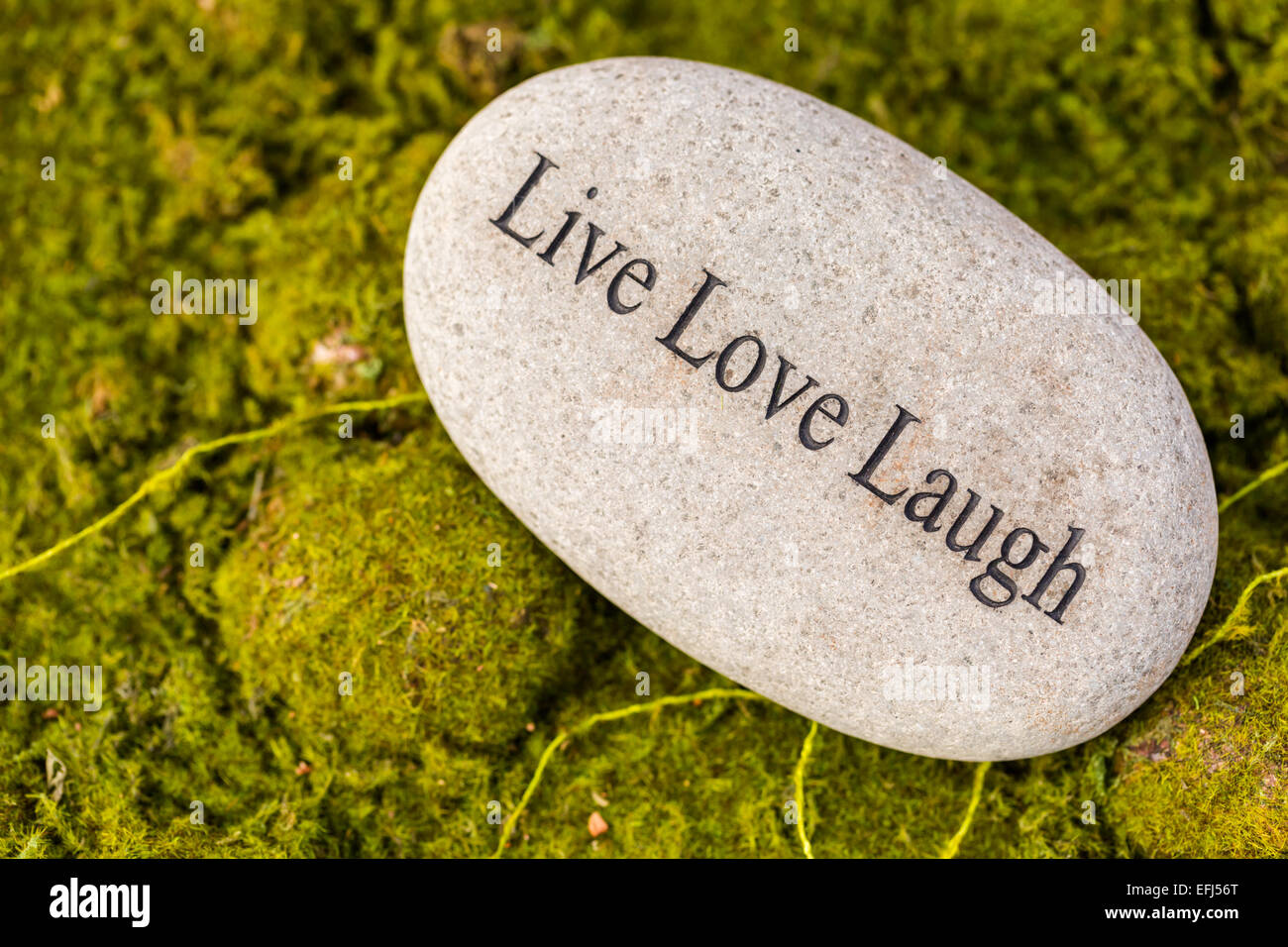 Small garden stones engraved with signs Stock Photo - Alamy