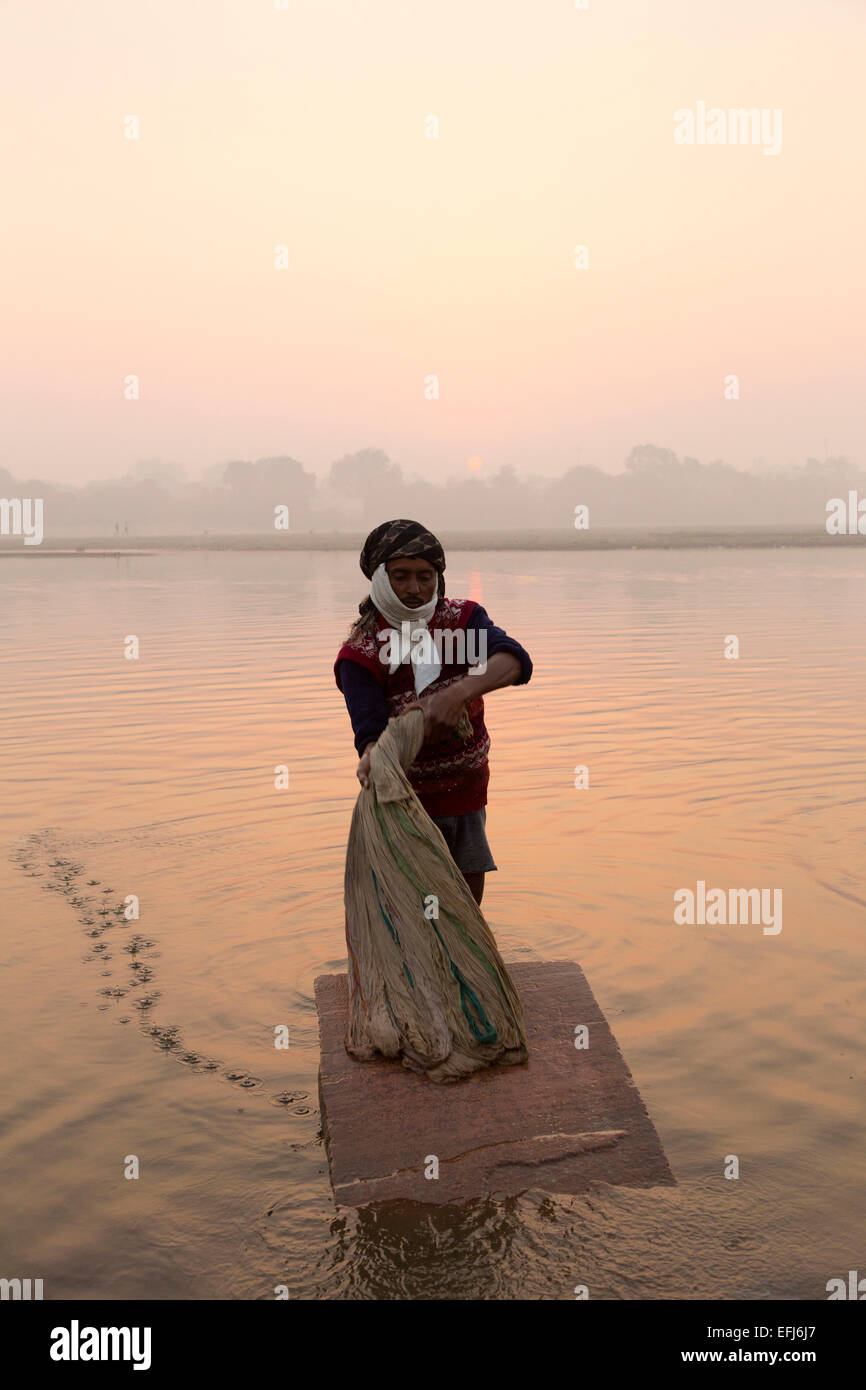 India, Uttar Pradesh, Agra, Dhobi-wallahs at sunrise on Yamuna River ...