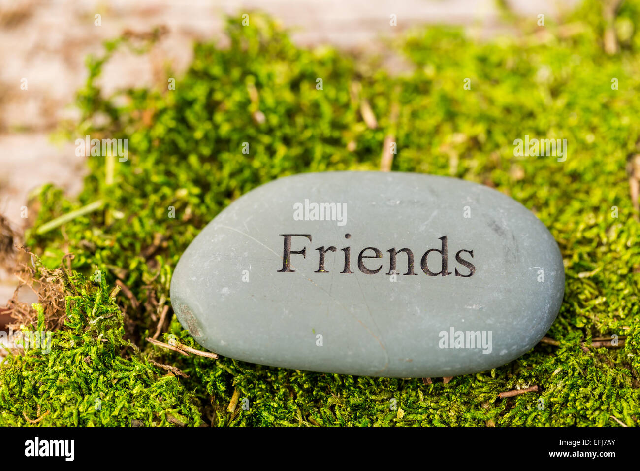 Small garden stones engraved with signs Stock Photo - Alamy