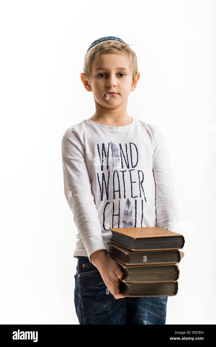 studio portrait of white boy with Jewish kipa or yarmulke and books ...