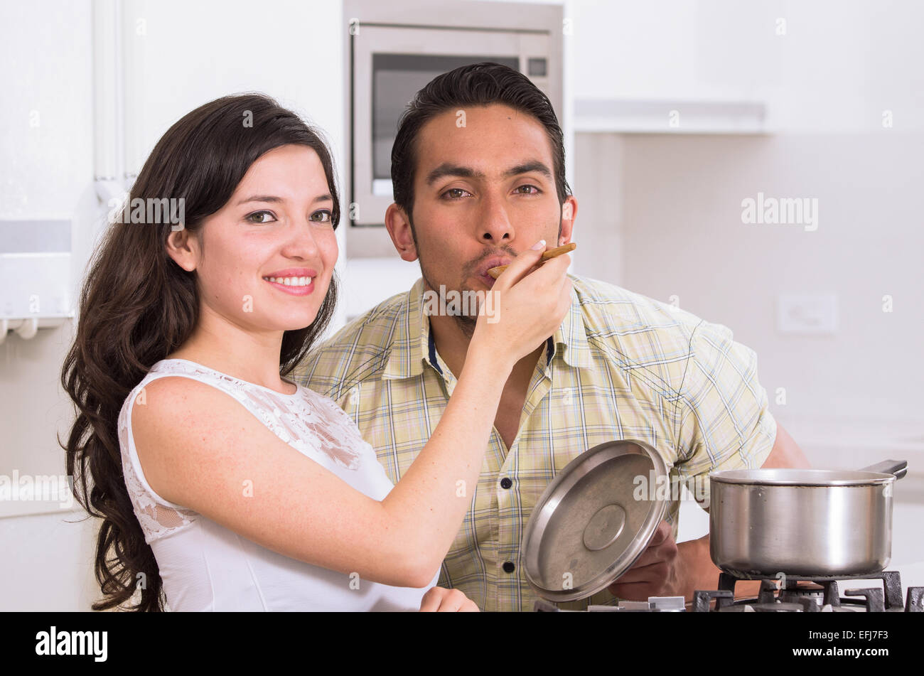 happy attractive couple cooking together Stock Photo - Alamy