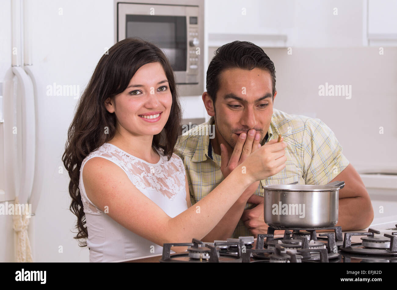 happy attractive couple cooking together Stock Photo - Alamy