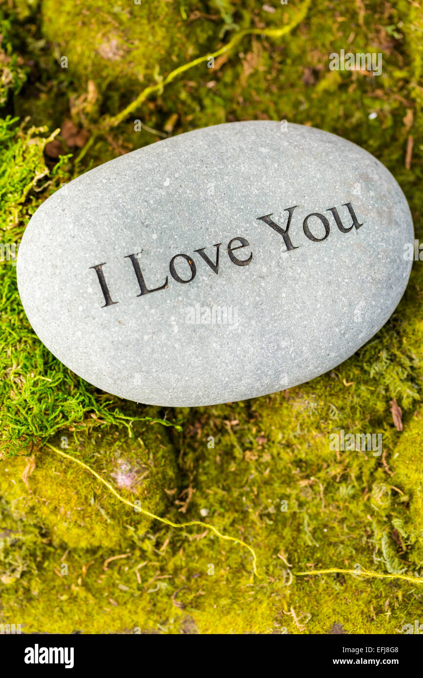 Small garden stones engraved with signs Stock Photo - Alamy