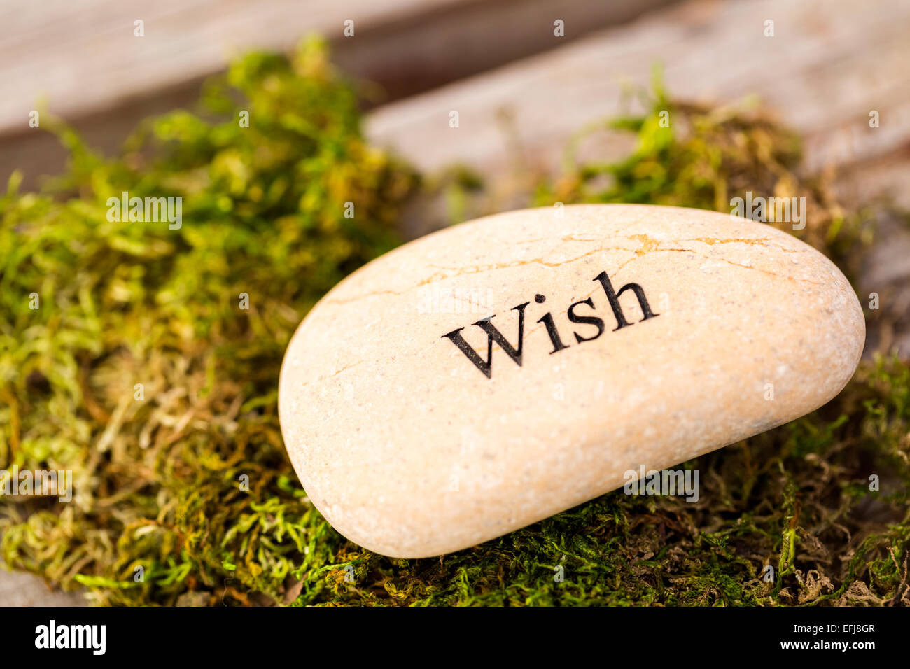 Small garden stones engraved with signs Stock Photo - Alamy
