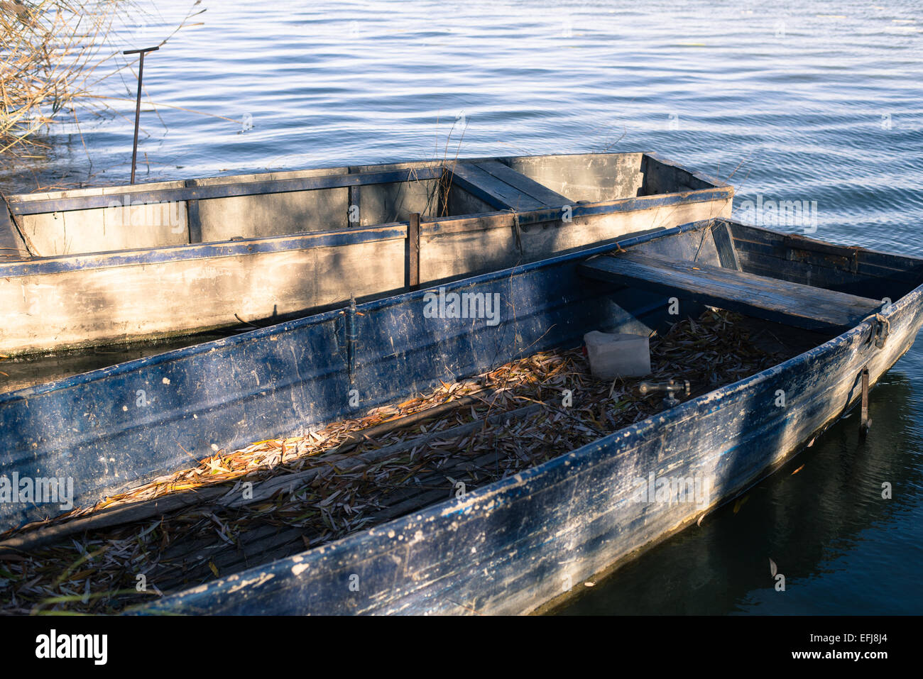Two boats at moorage on a lake Stock Photo - Alamy