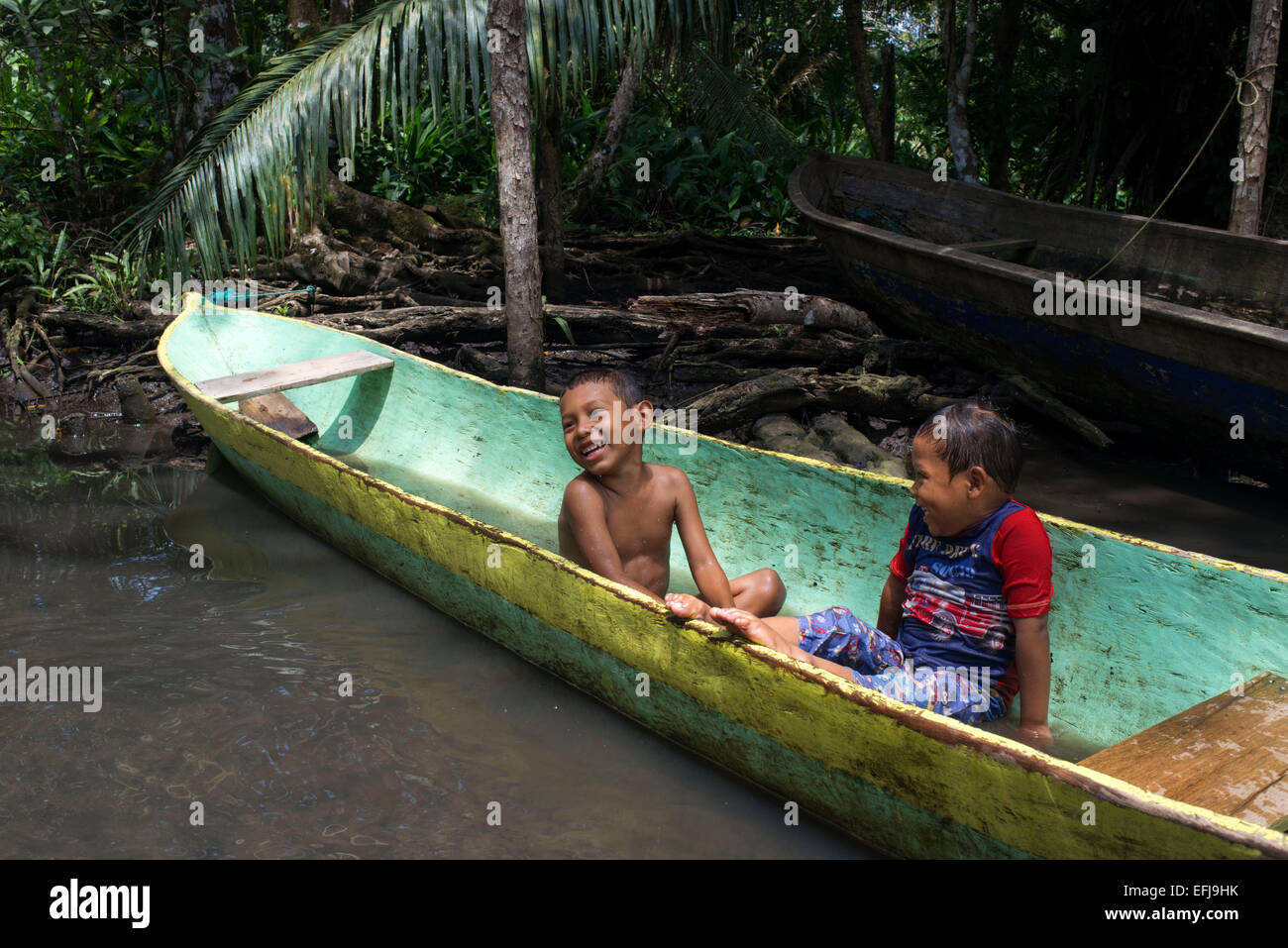 Kids play in one of the local boats used by the Ngobe Indians as their ...
