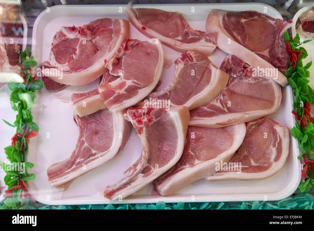 Pork chops in butchers windows Stock Photo - Alamy