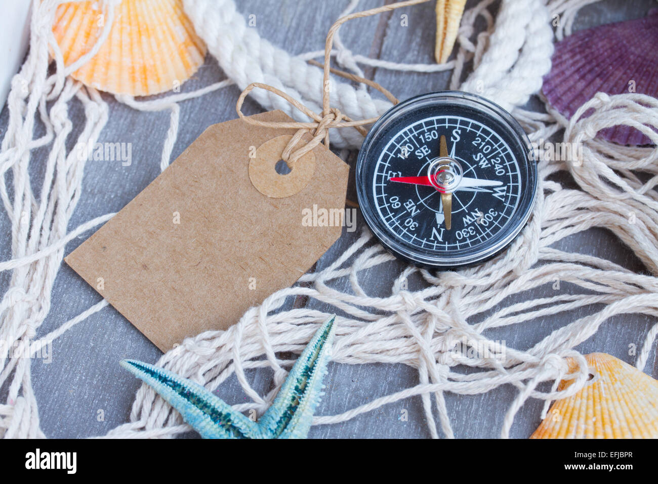 compass on fishing net with tag Stock Photo - Alamy