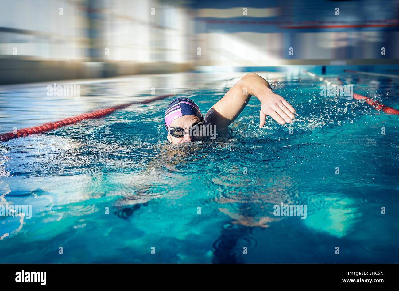Young man swimming Stock Photo - Alamy