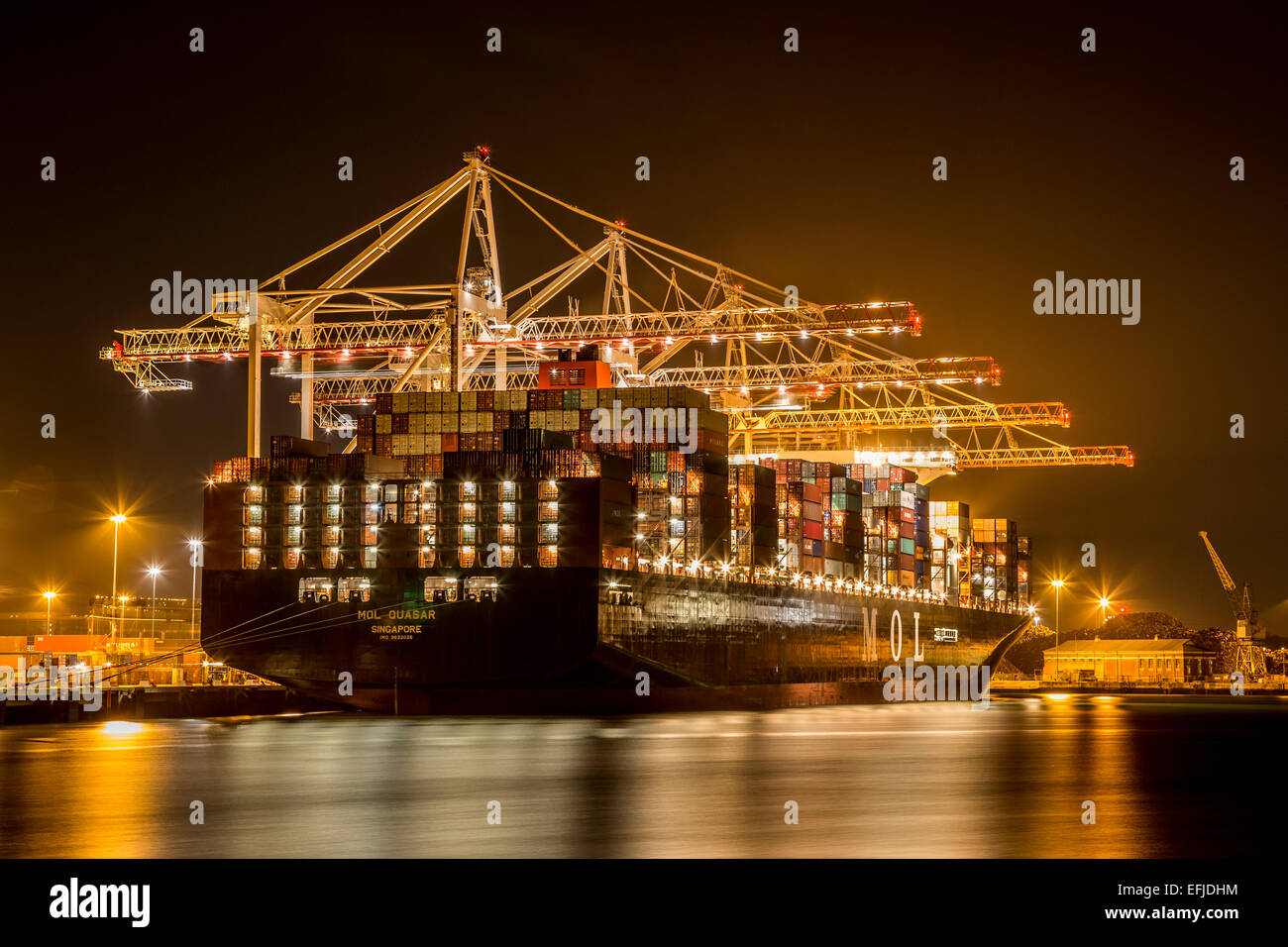 Busy docks loading a shipping container Stock Photo - Alamy