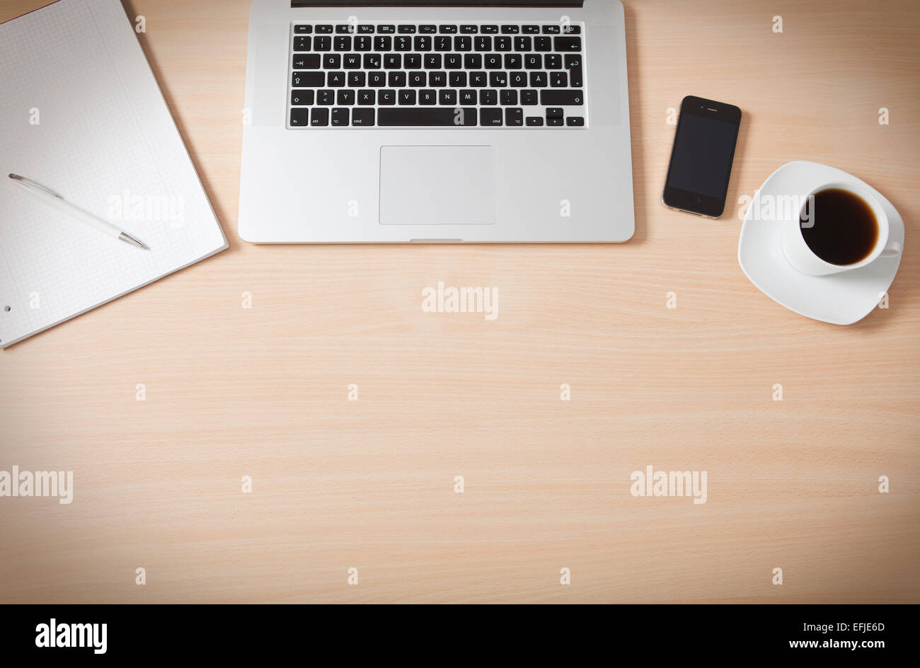 Desk with laptop and coffee in an office Stock Photo - Alamy