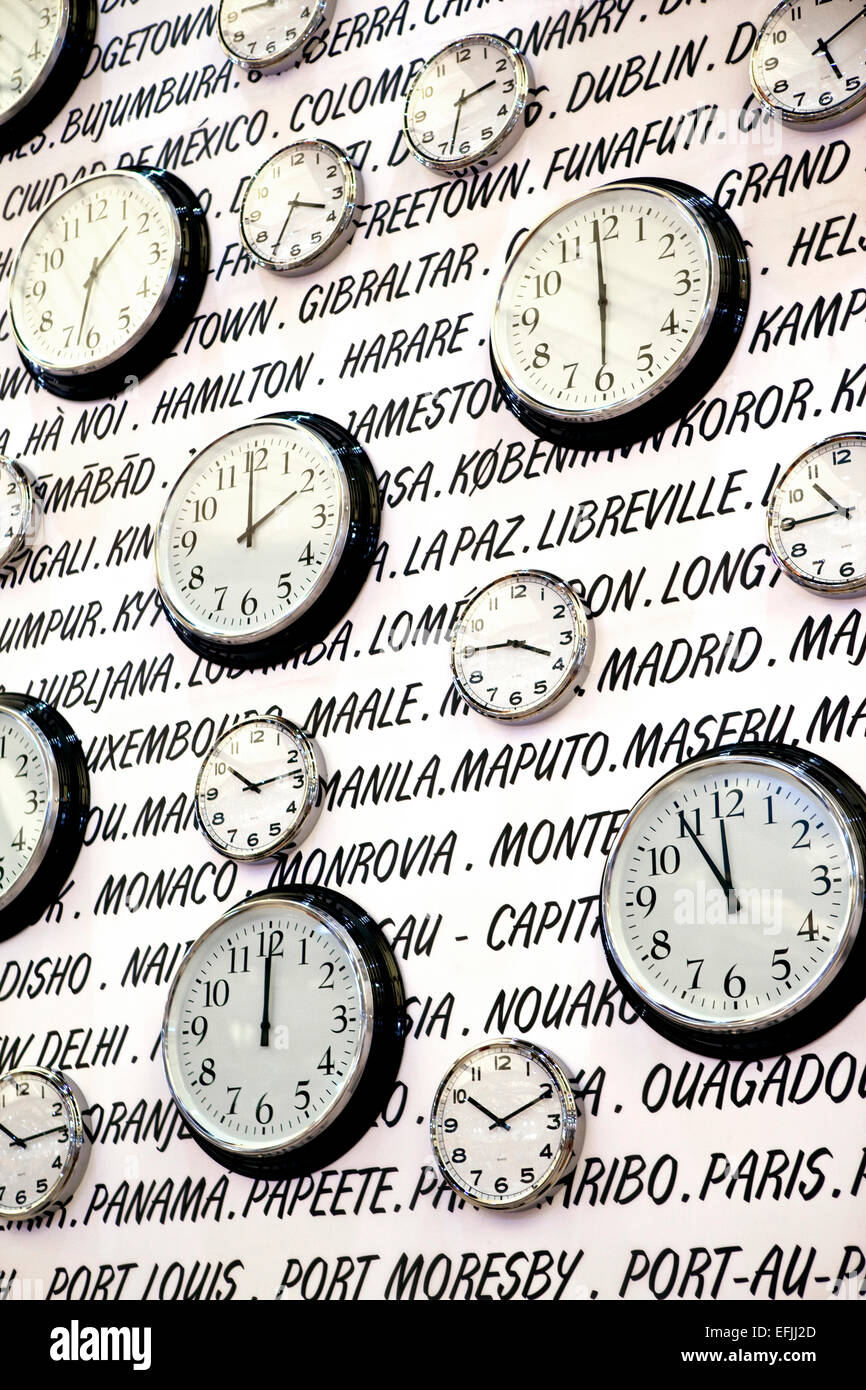 Clocks and capitals on a wall Stock Photo - Alamy