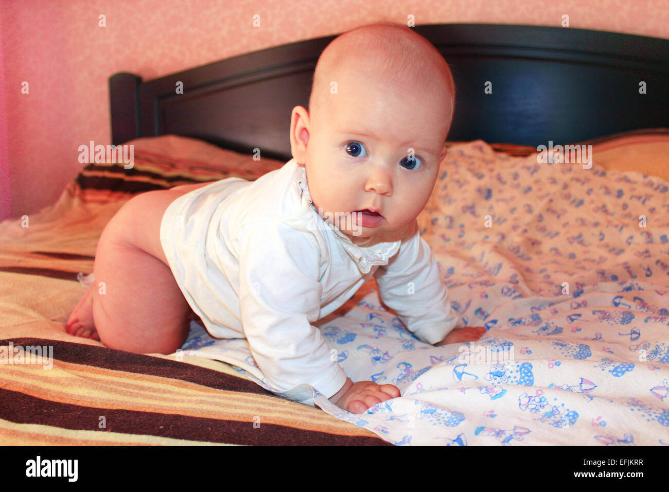 little lovely baby lying on the bed in marvelous pose Stock Photo - Alamy
