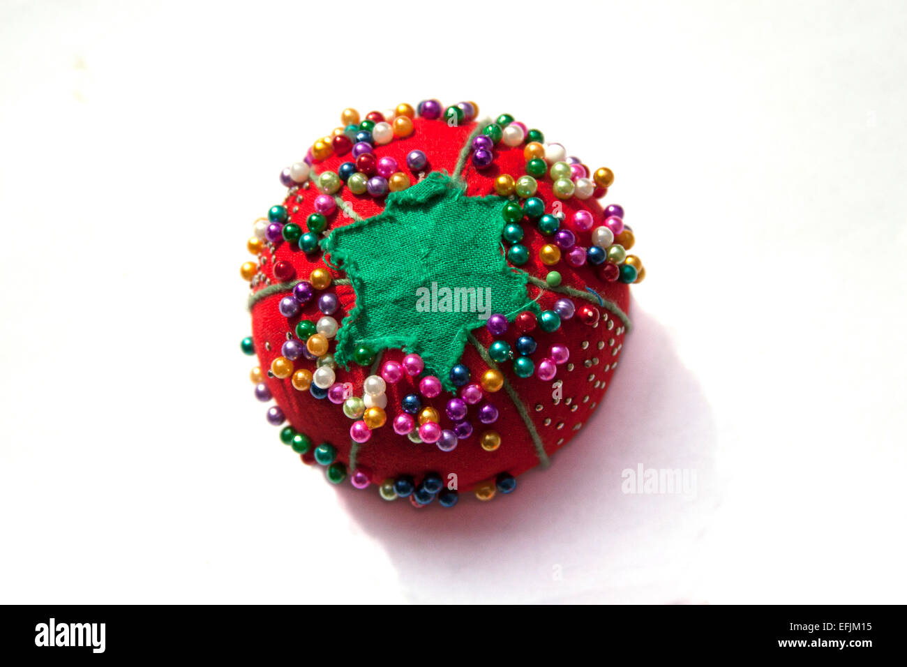 Red Pincushion with Colorful Pins Stock Photo - Alamy