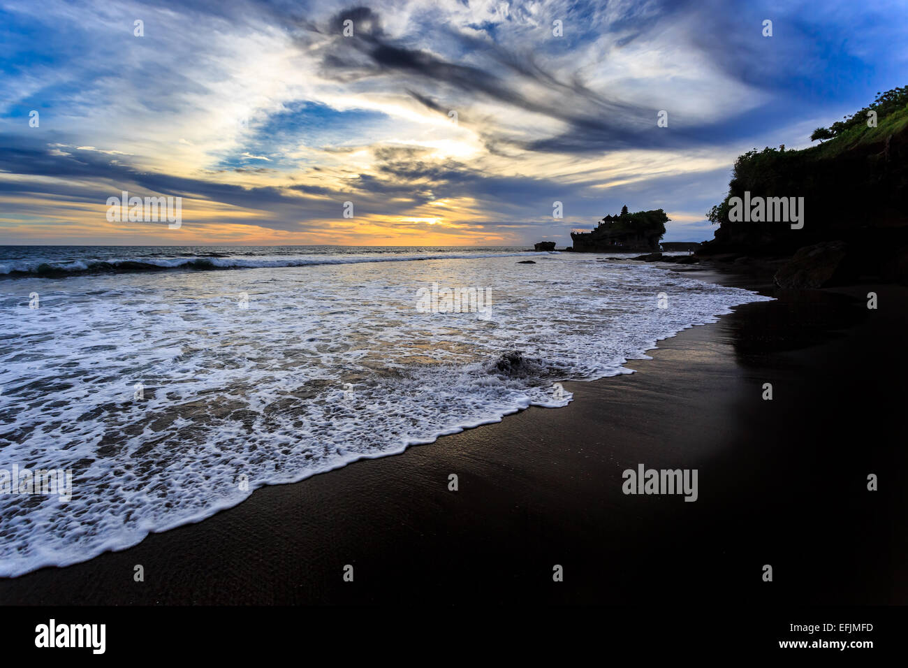 Tahah Lot Temple and ocean waves at sunset, Bali, Indonesia Stock Photo ...