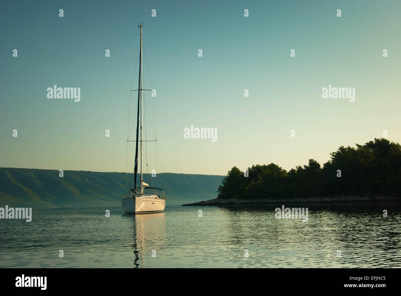 Sailing yacht anchored in a bay Stock Photo - Alamy