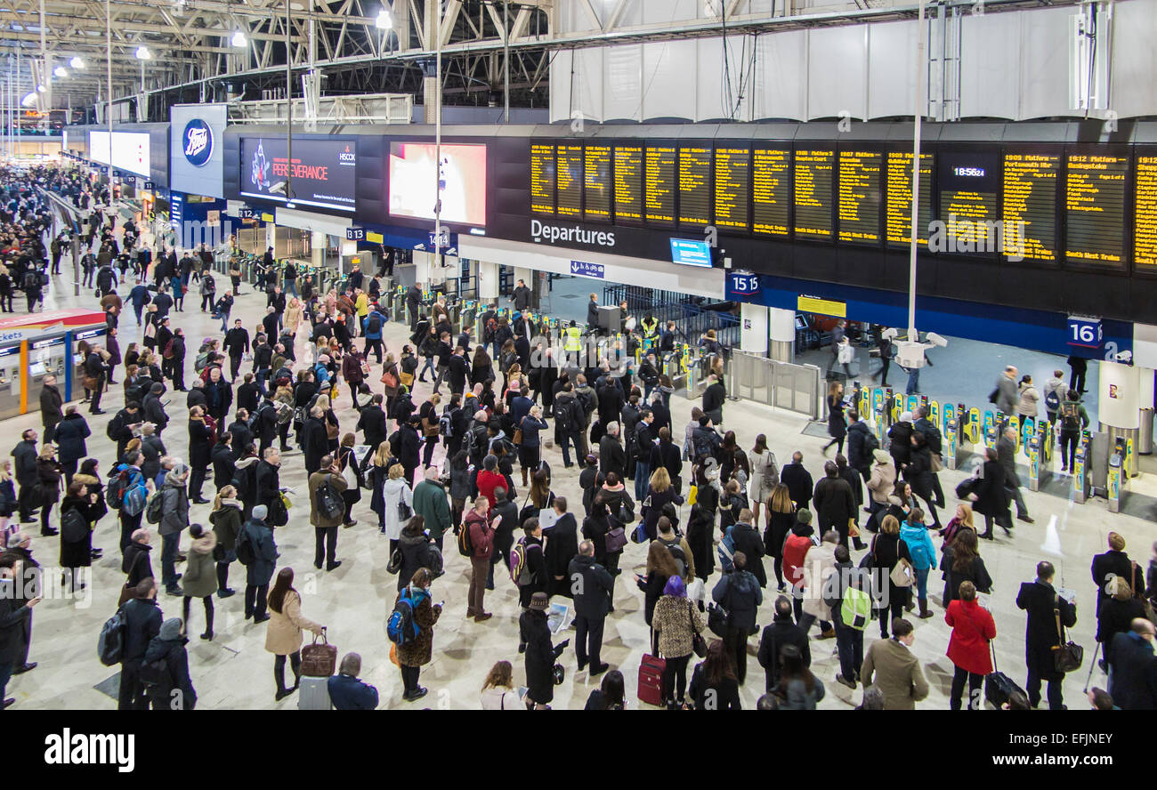 London Waterloo Station concourse, crowded with early evening commuters ...