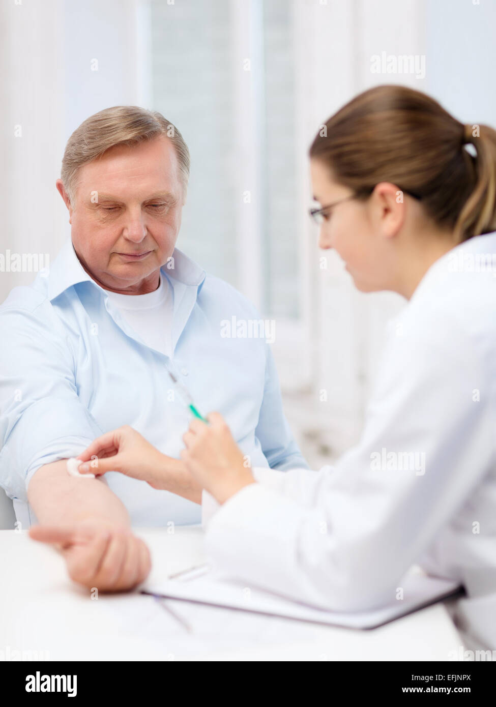 female doctor doing injection to old man Stock Photo - Alamy