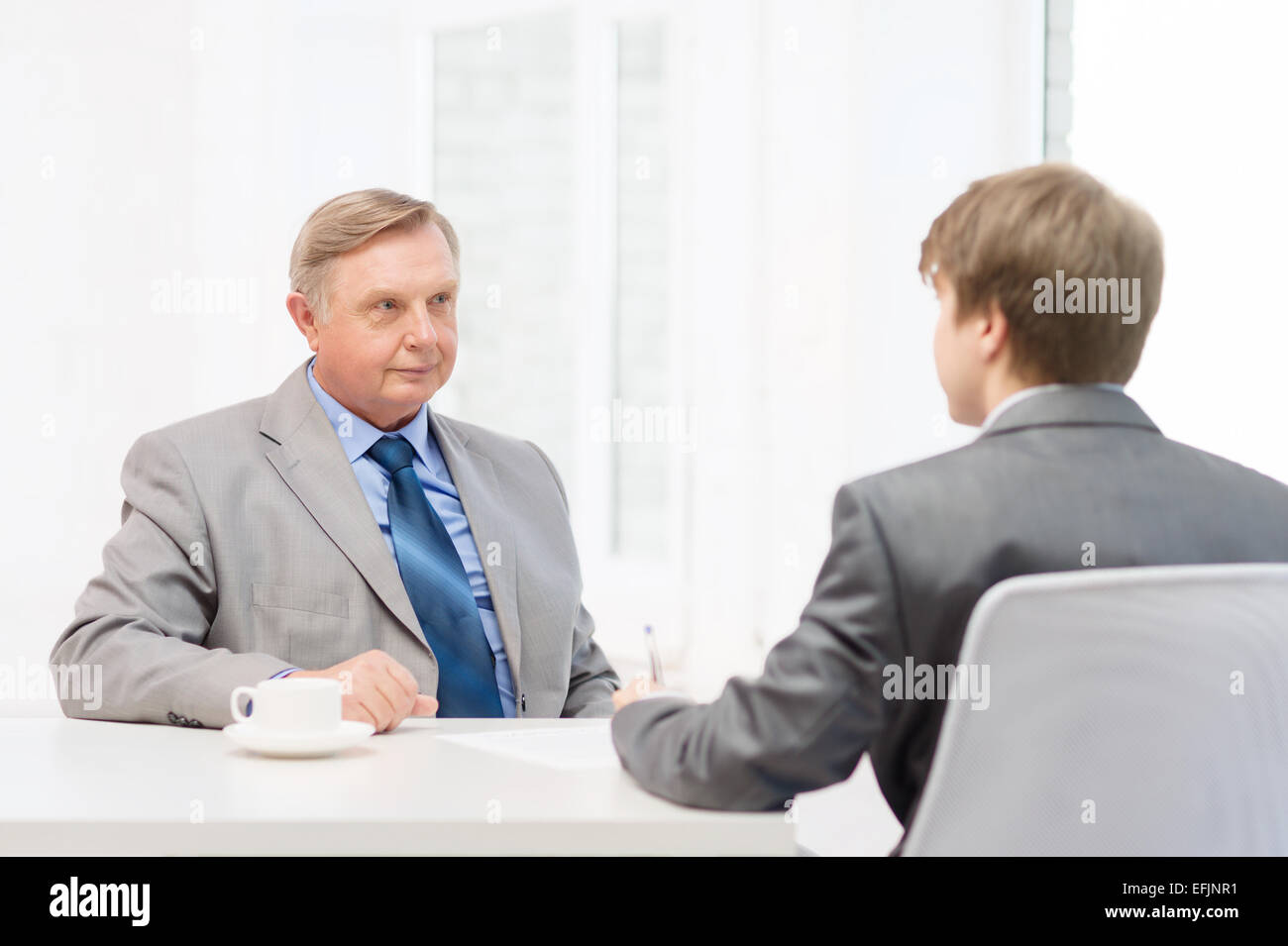 Elderly man signing papers hi-res stock photography and images - Alamy