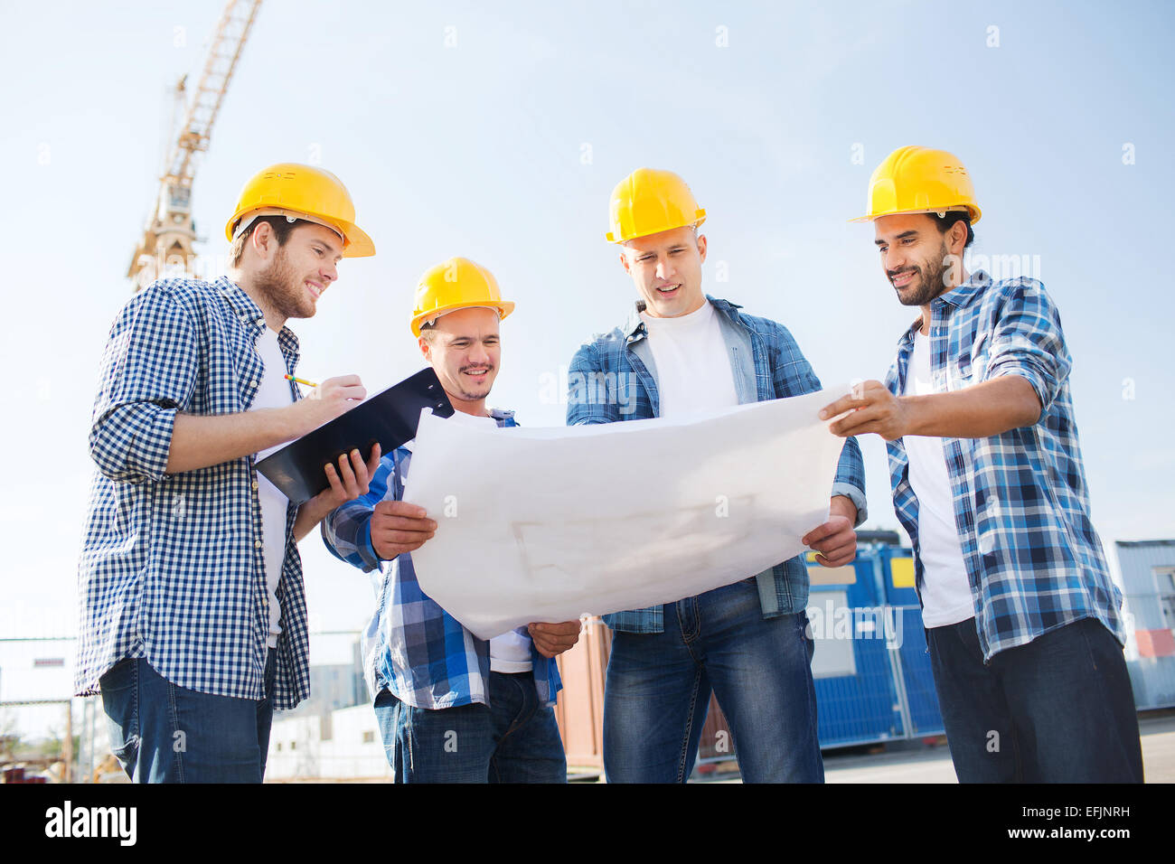 group of builders with tablet pc and blueprint Stock Photo - Alamy