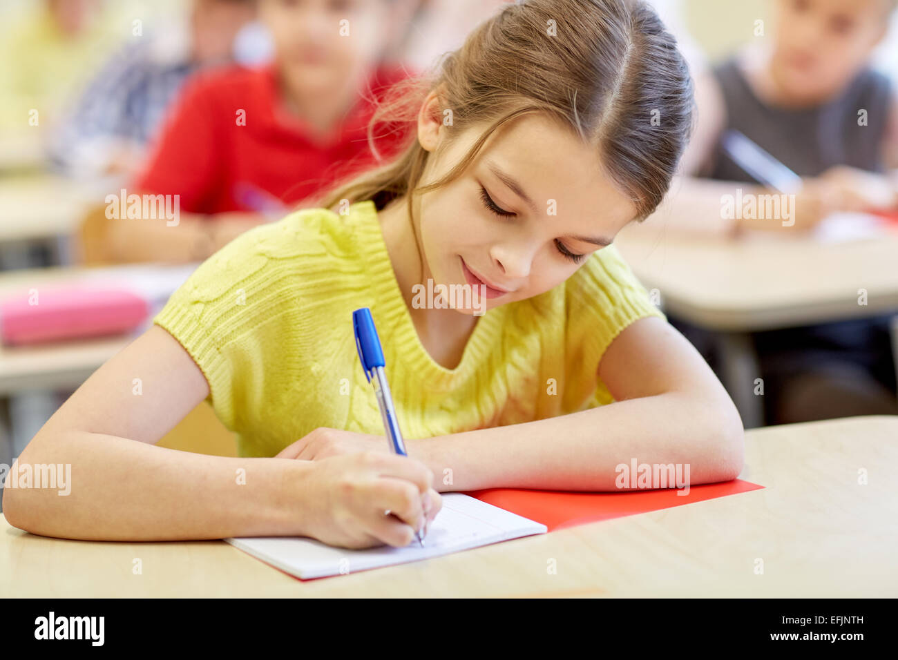 group of school kids writing test in classroom Stock Photo - Alamy