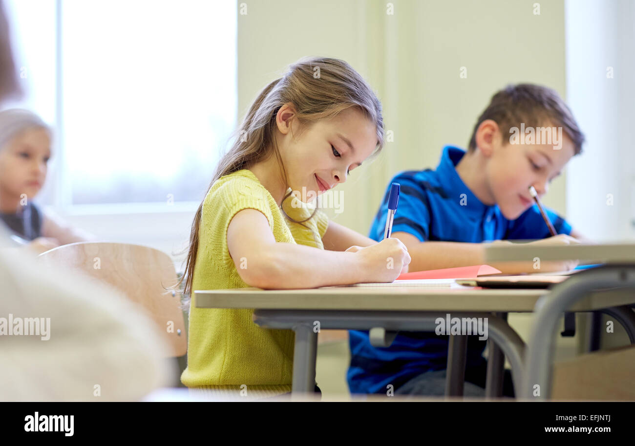 group of school kids writing test in classroom Stock Photo - Alamy