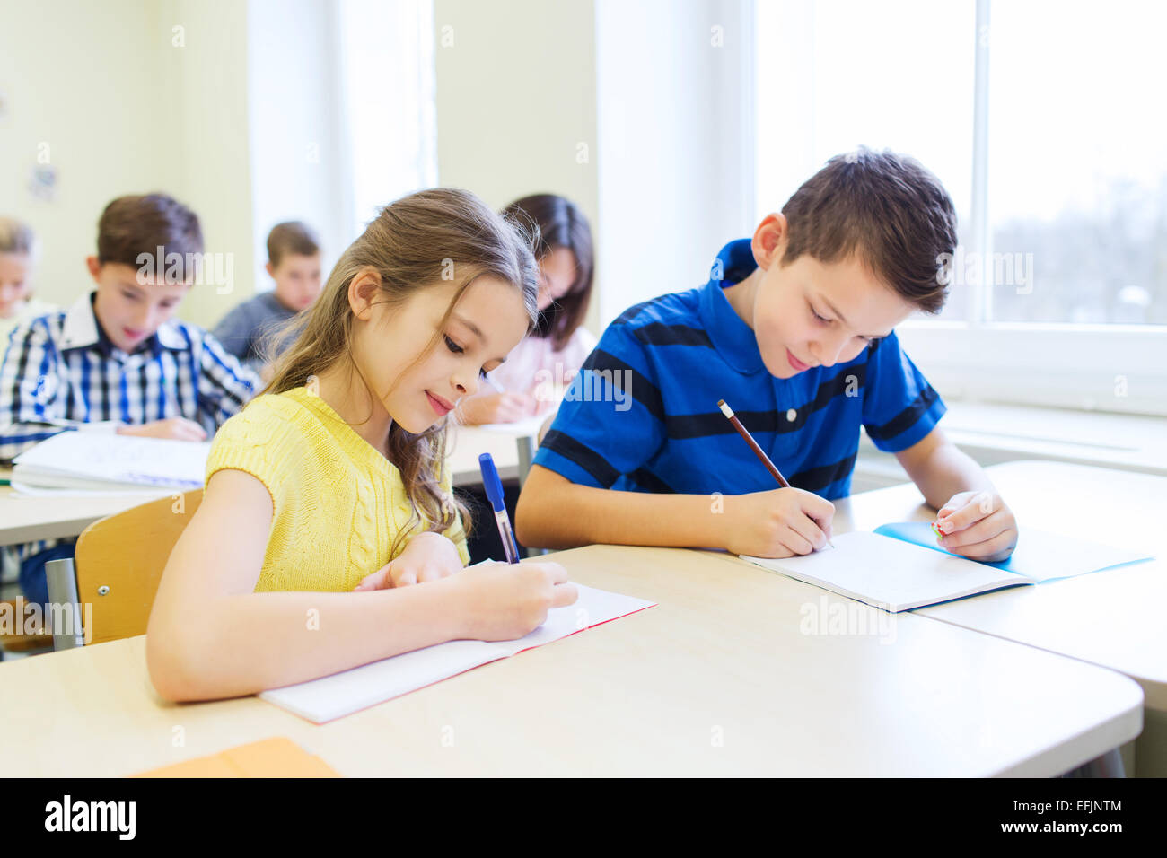 Children Writing In School