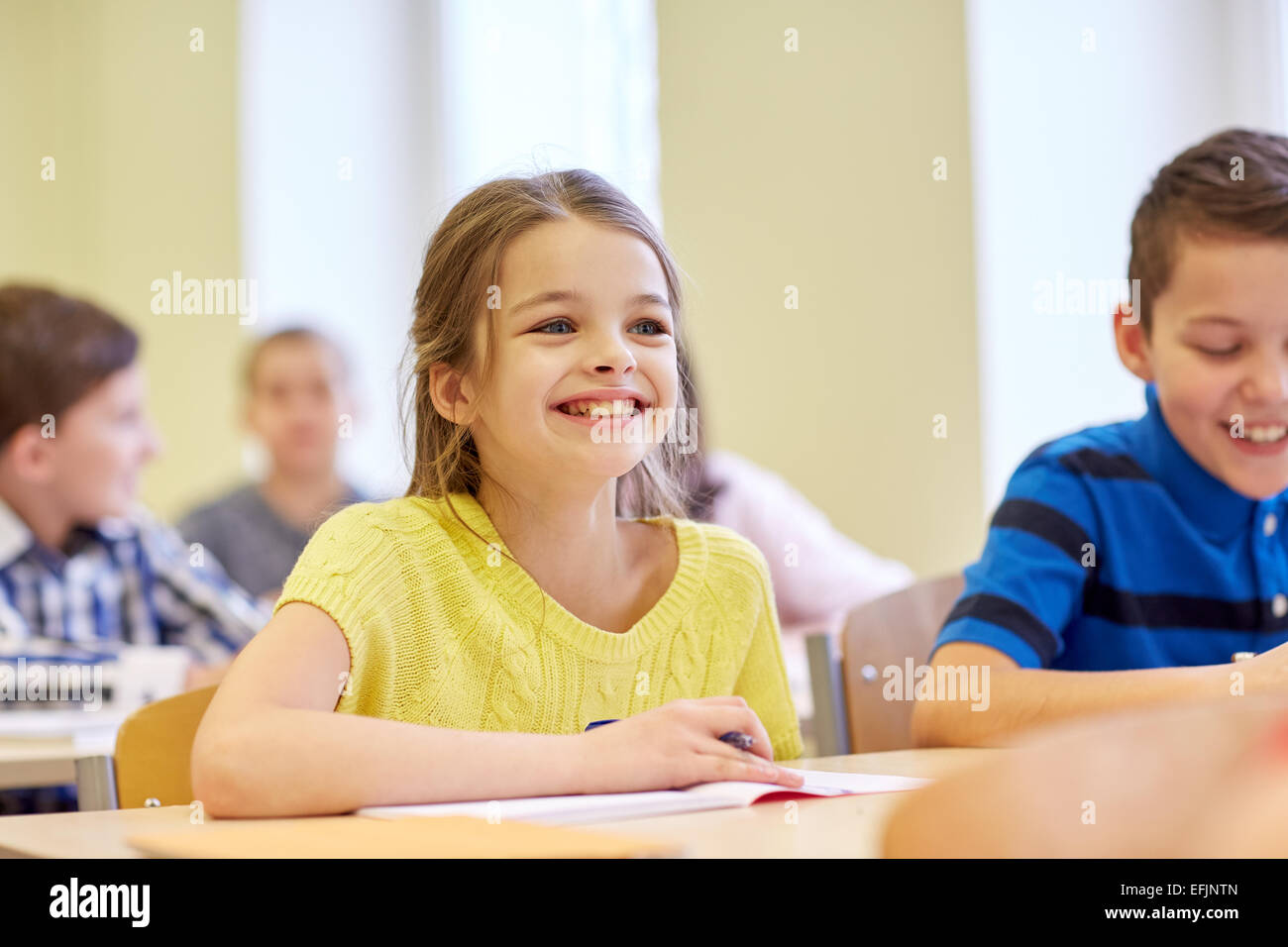 group of school kids writing test in classroom Stock Photo - Alamy