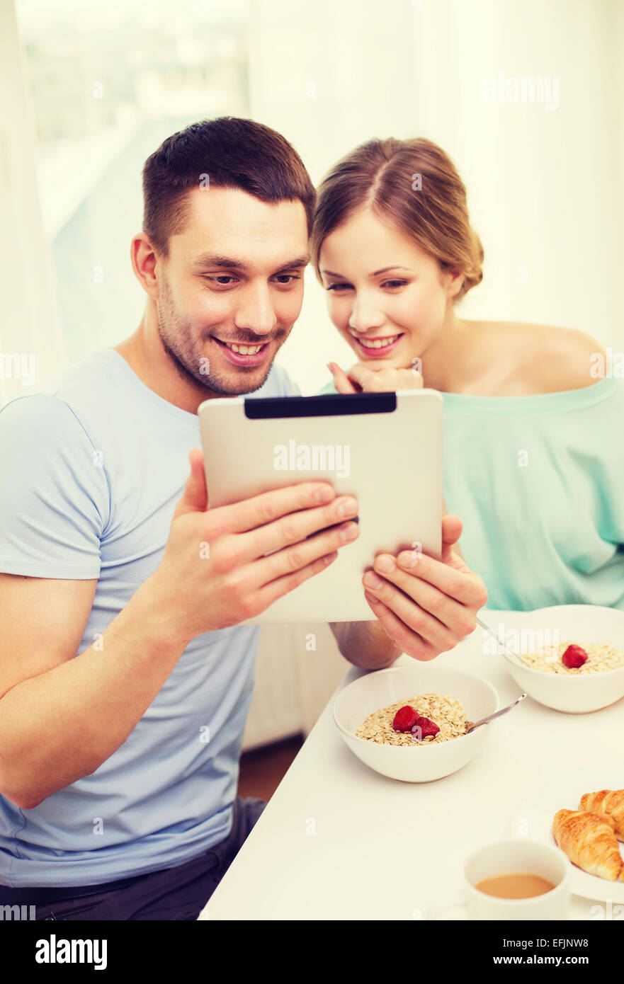 smiling couple with taking picture with tablet pc Stock Photo - Alamy