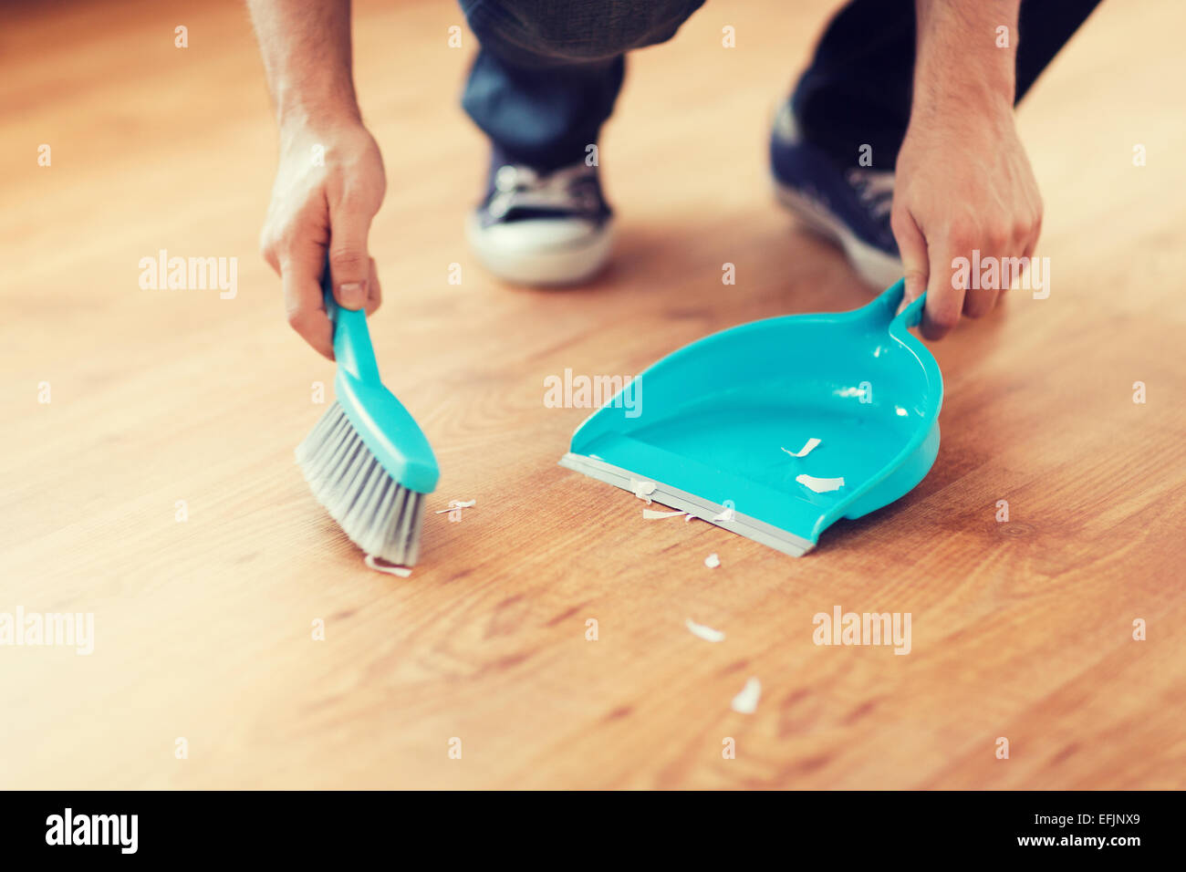 Man sweeping floor dustpan broom hi-res stock photography and images ...