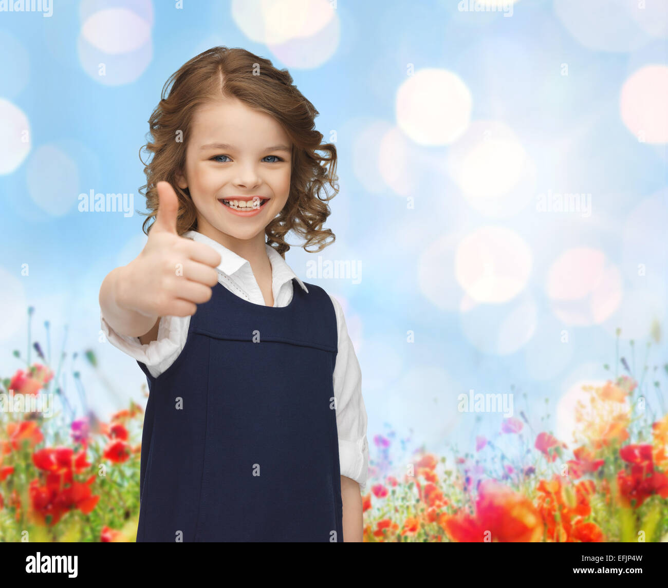 happy little school girl showing thumbs up Stock Photo - Alamy