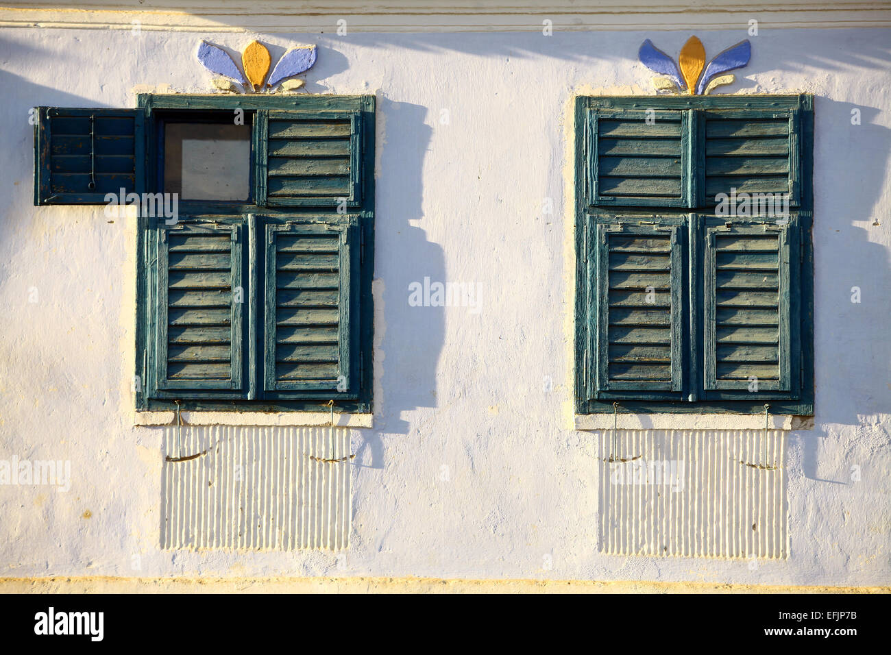 Color shot of a wooden window with closed shutters Stock Photo - Alamy