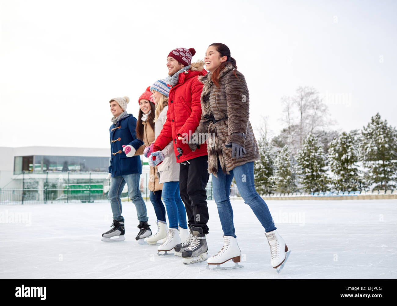 happy friends ice skating on rink outdoors Stock Photo - Alamy
