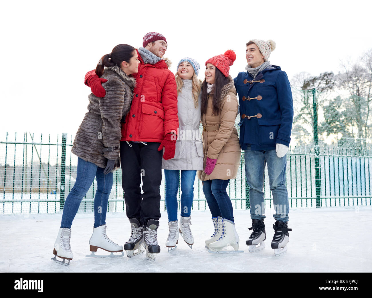 happy friends ice skating on rink outdoors Stock Photo - Alamy