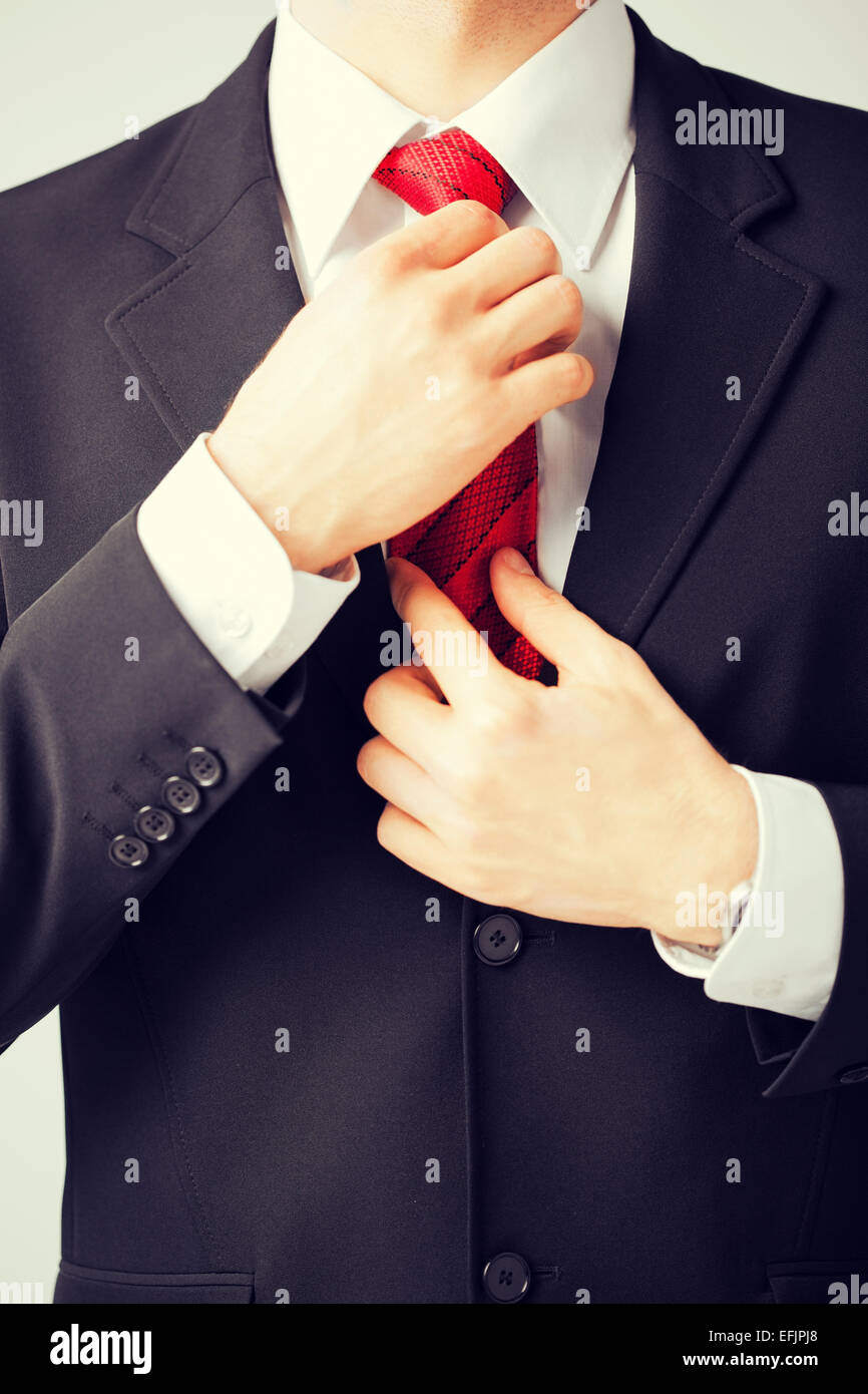 man adjusting his tie Stock Photo - Alamy