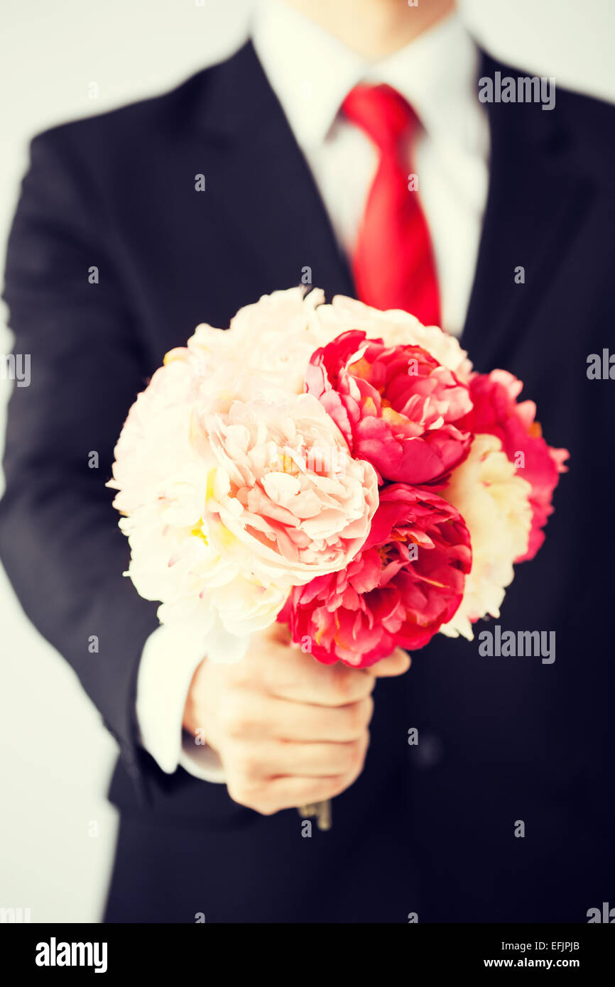 man giving bouquet of flowers Stock Photo - Alamy