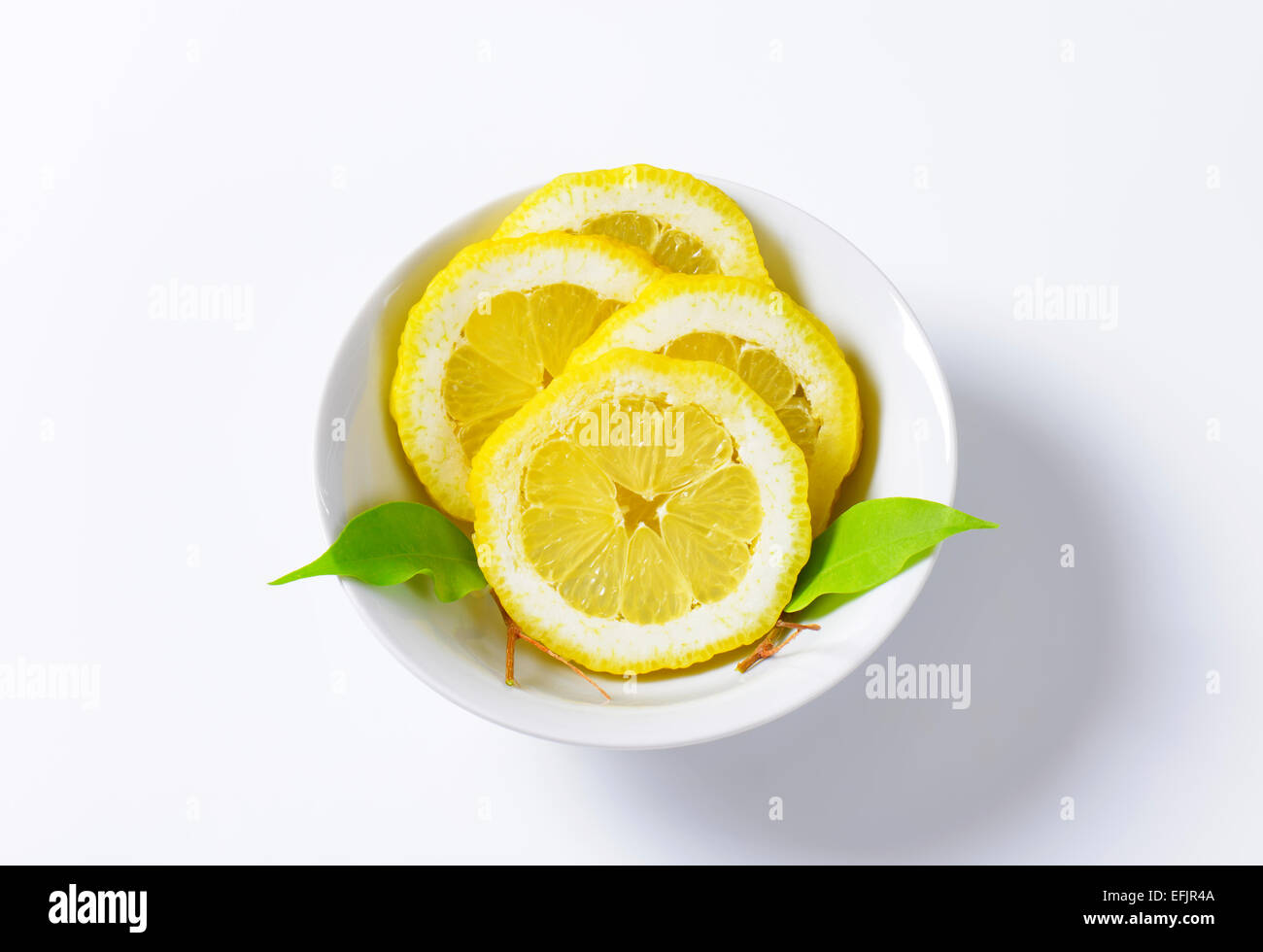 Slices of fresh lemon in a bowl Stock Photo - Alamy