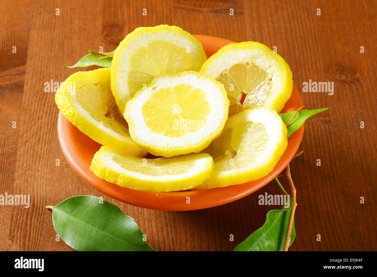 Slices of fresh lemon in a bowl Stock Photo - Alamy