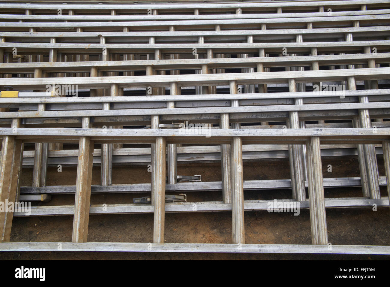 Stack of ladders on ground at a construction site Stock Photo - Alamy