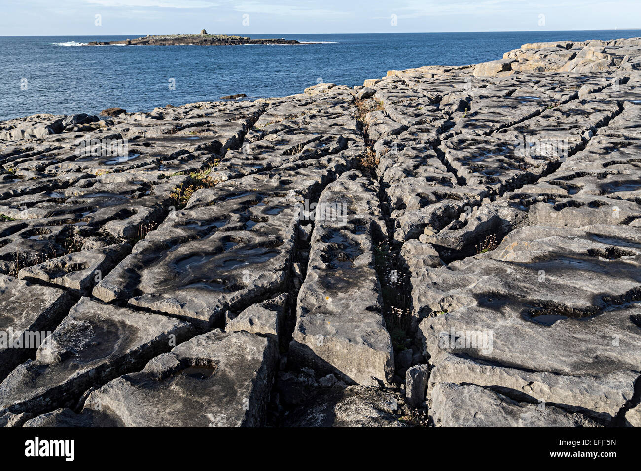 Limestone pavement with clints and grikes with Crab Island and ruined ...