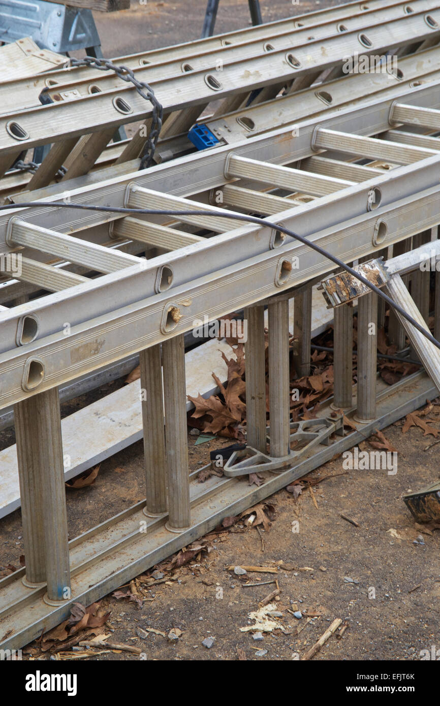 Stack of ladders on ground at a construction site Stock Photo - Alamy