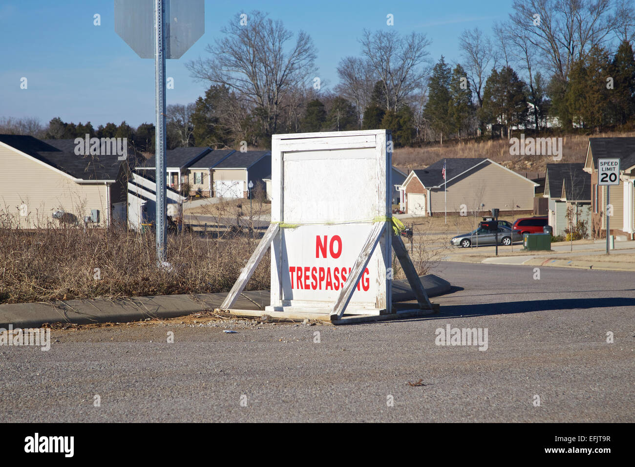 Wooden no trespassing sign on road in front of neighborhood Stock Photo ...
