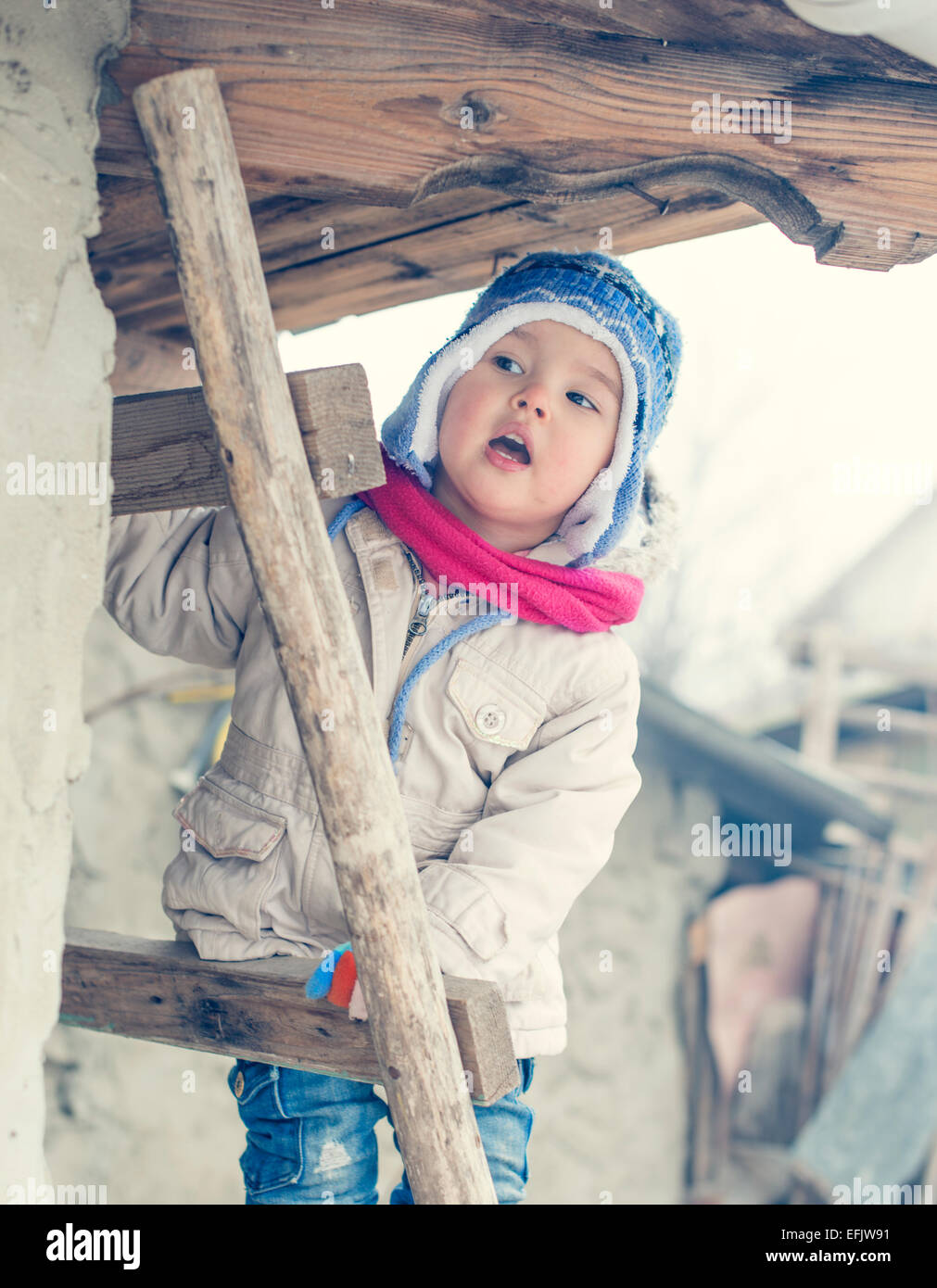 Baby climbing up the ladder Stock Photo - Alamy