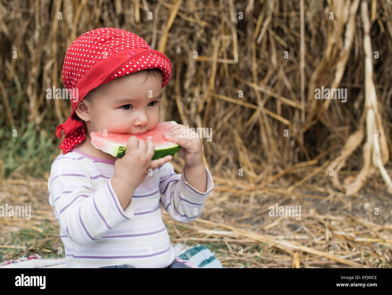 Toddler eating melon hi-res stock photography and images - Alamy