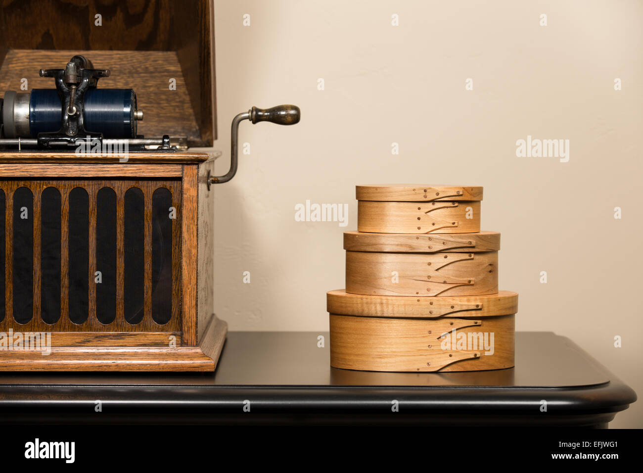 Vintage hand-crafted shaker boxes next to antique cylindrical ...