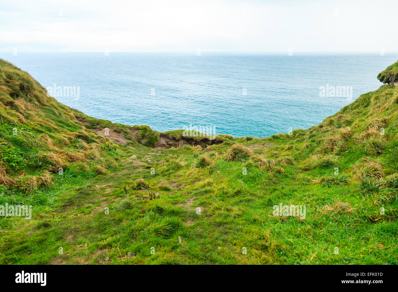 Atlantic ocean overcast sky and field of green grass, Ireland Europe ...